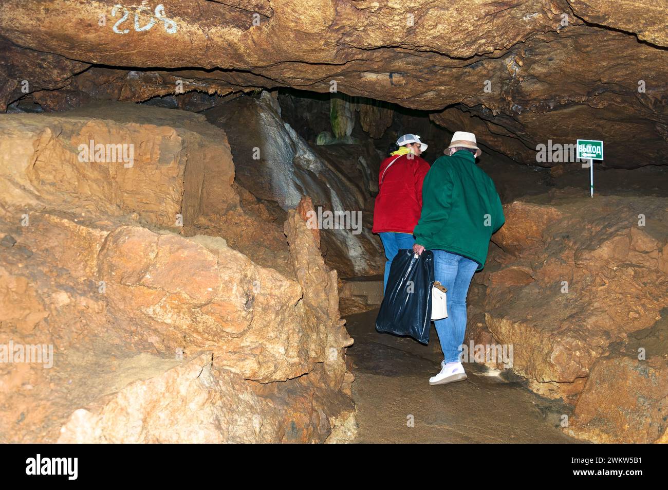 Two women, members of the tourist group, pose against the backdrop of ...