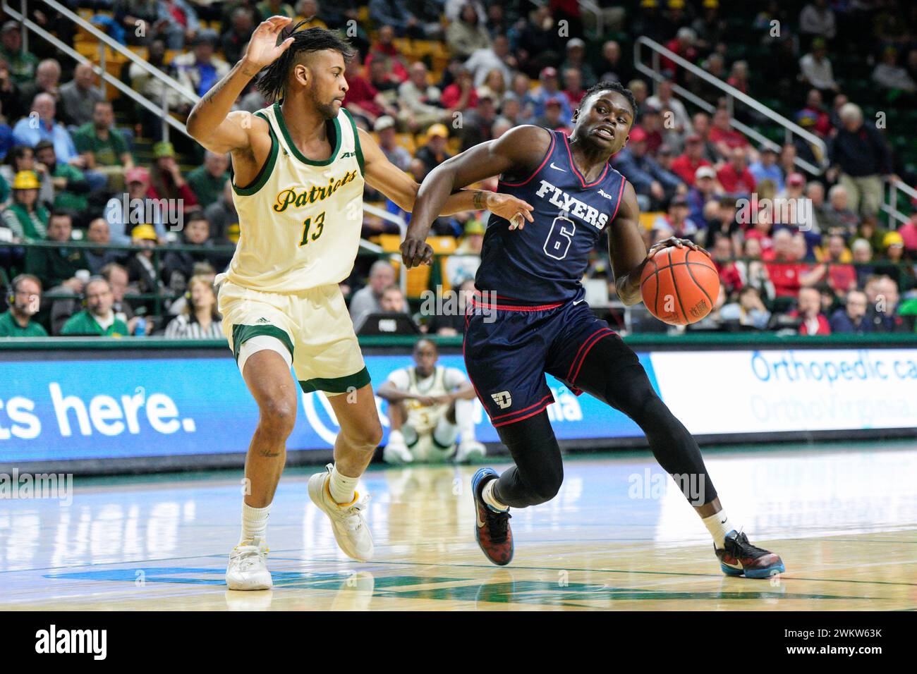 Dayton guard Enoch Cheeks (6) drives to the basket against George Mason ...