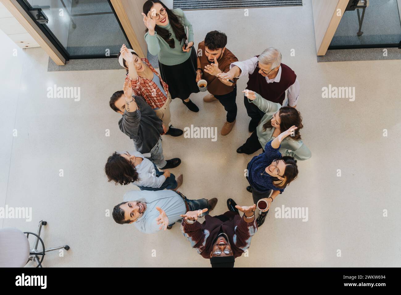 Overhead shot captures a warm moment as a diverse group of individuals ...