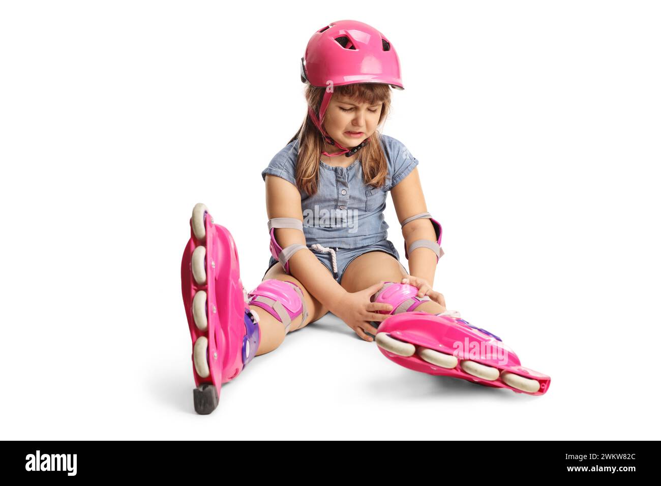 Sad girl with roller blades crying and sitting on the floor with an ...