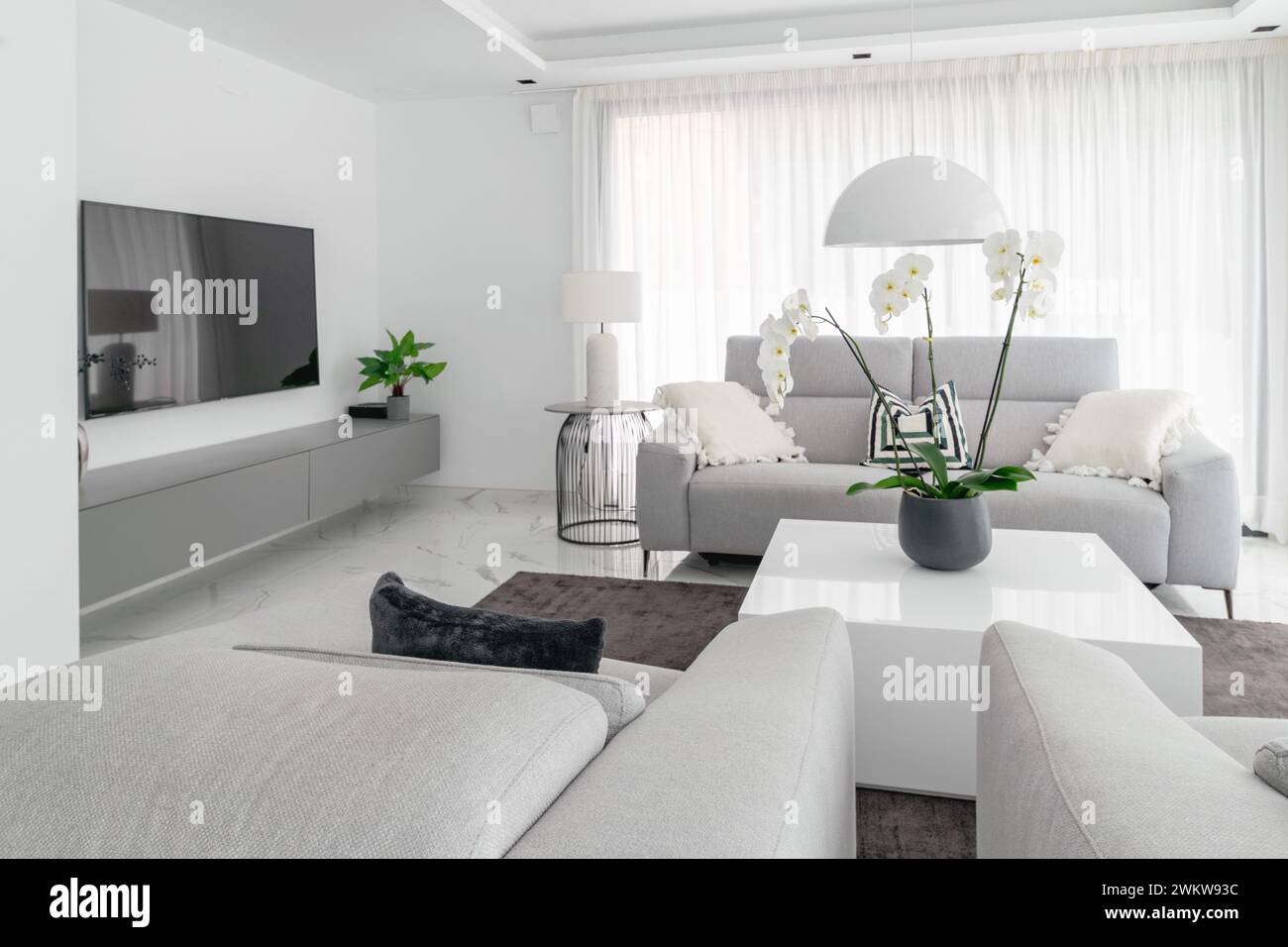 a newly furnished luxury white living room space in mediterranean ...