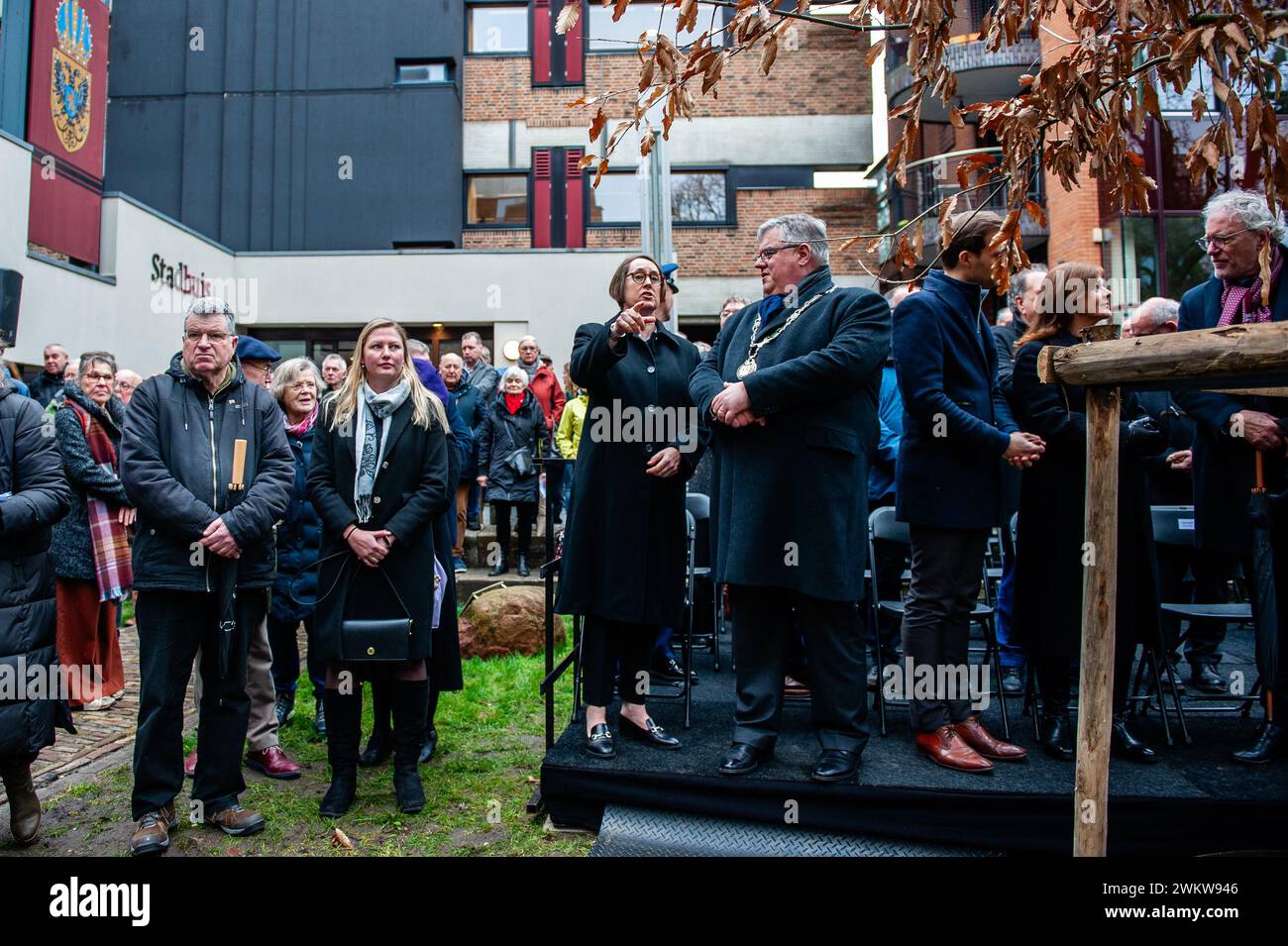 A representative from the American embassy (left) is seen talking with ...