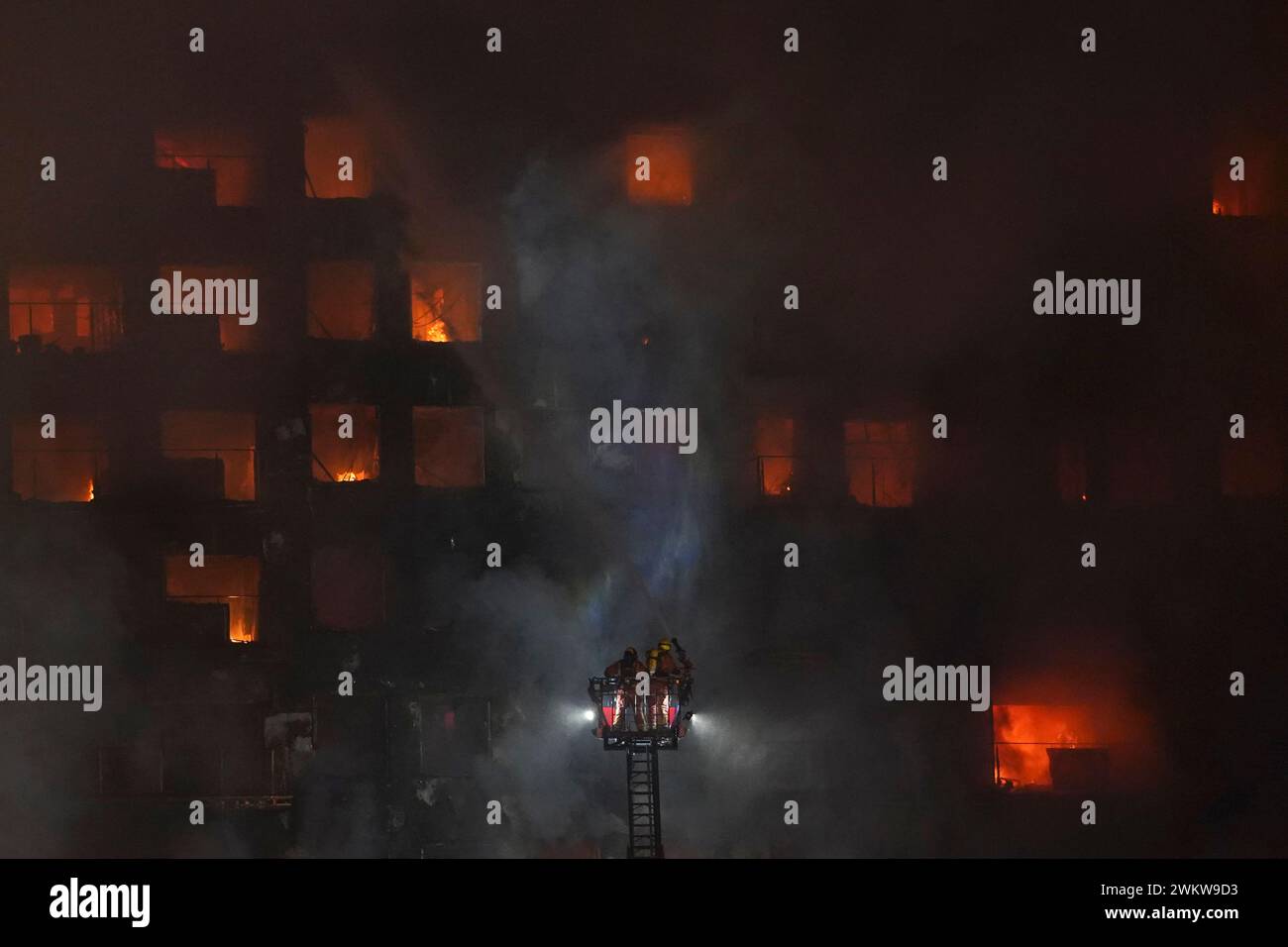 Firefighters work as a housing block burns in Valencia, Spain, Thursday ...