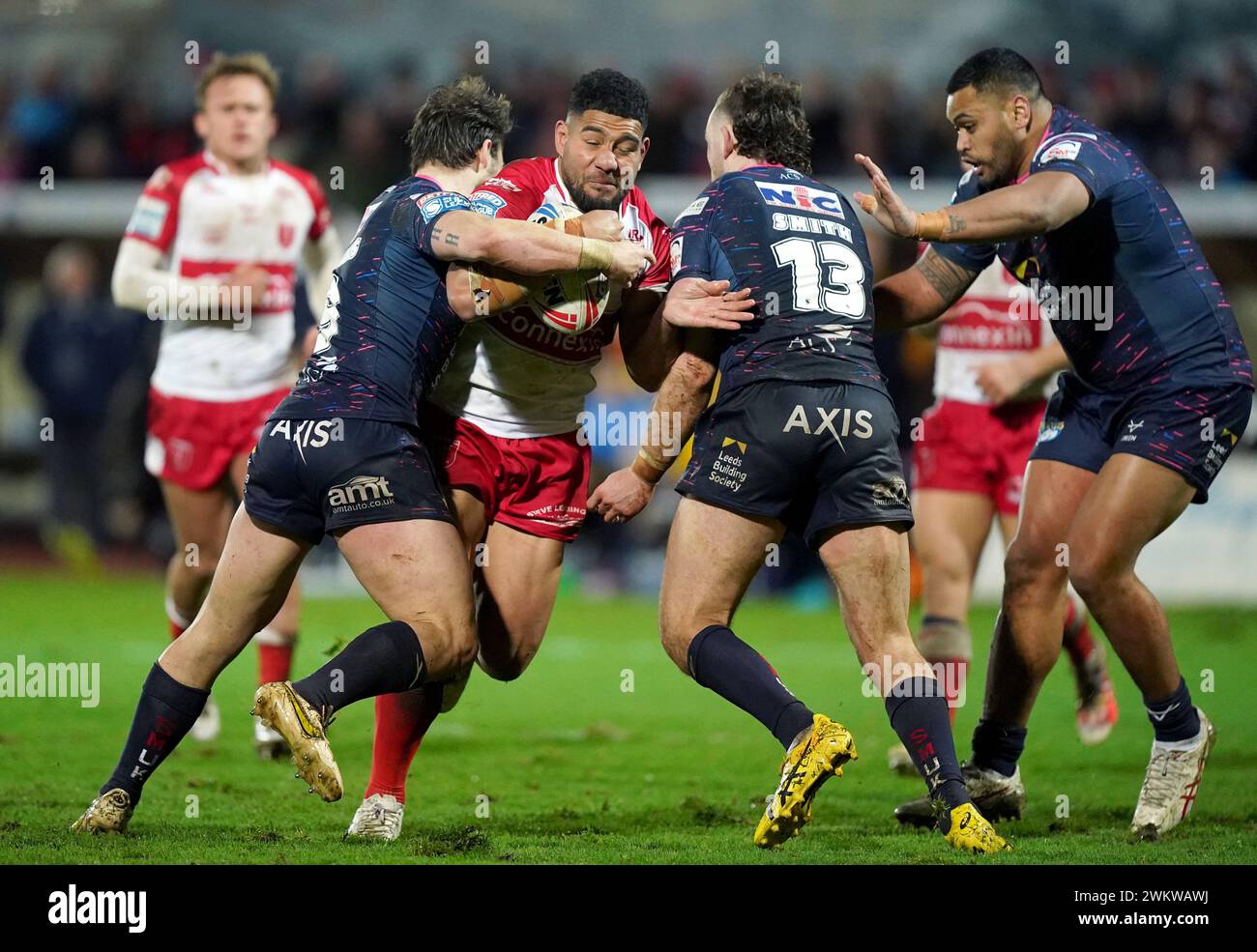 Hull KR's Kelepi Tanginoa is tackled by Leeds Rhino's Andy Ackers (left ...