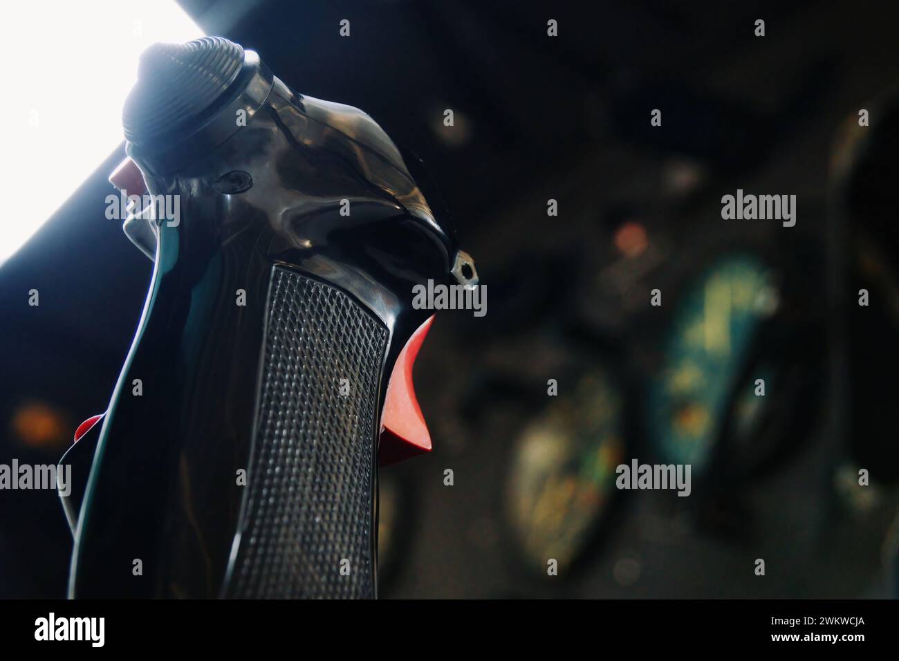 Close-up shot of a black flight-stick onboard a military war gunship ...