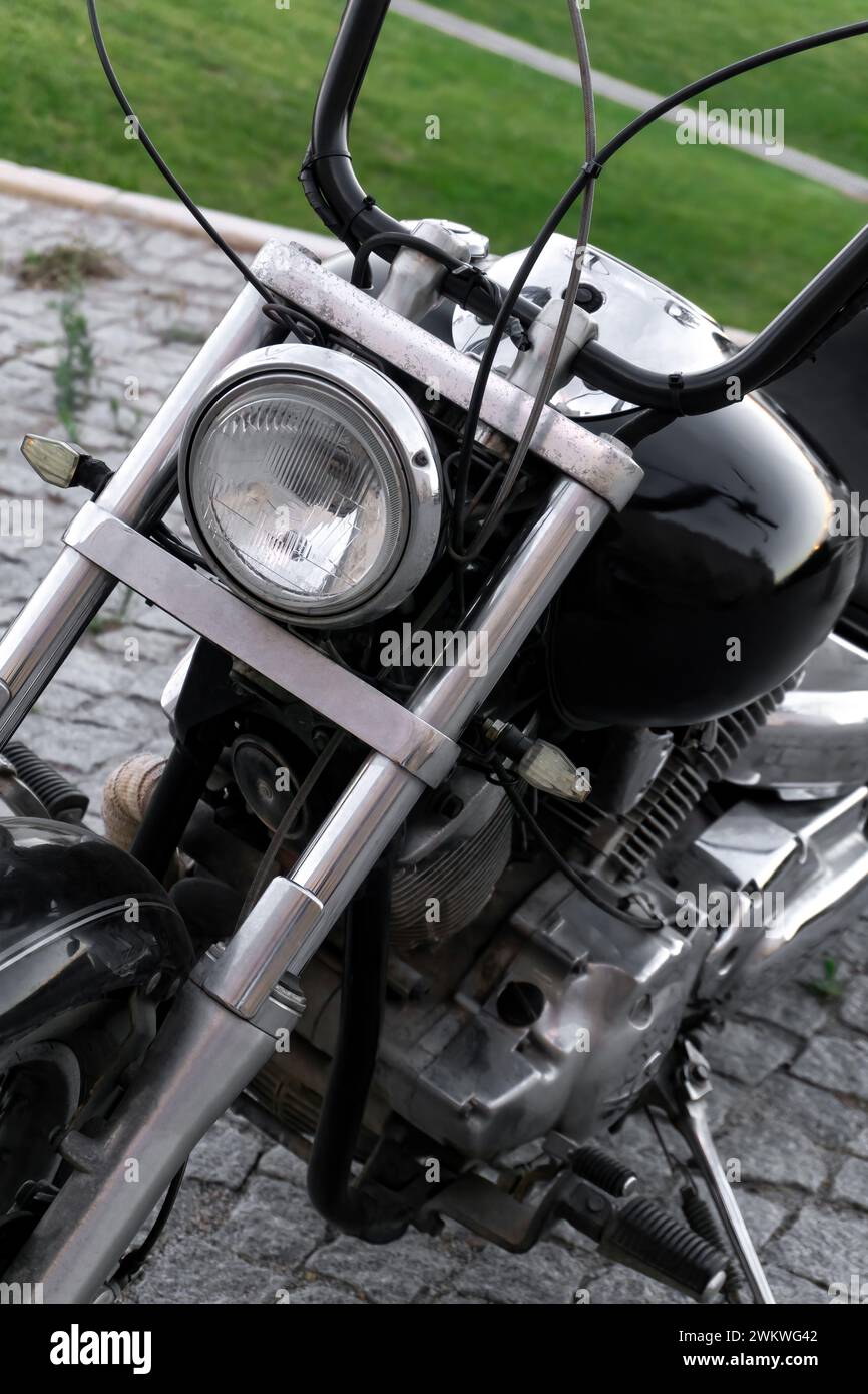 Detail of classic black chopper motorcycle front headlight and chrome ...