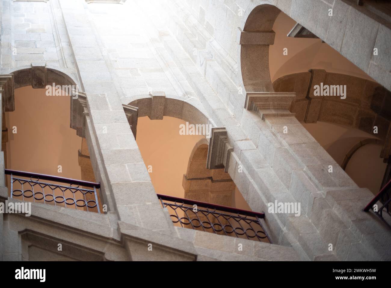 Interior of an ancient building with stairs, columns and arches ...