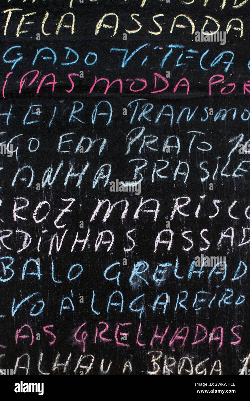 Detail of a portuguese menu written in multicolored chalk on a black ...