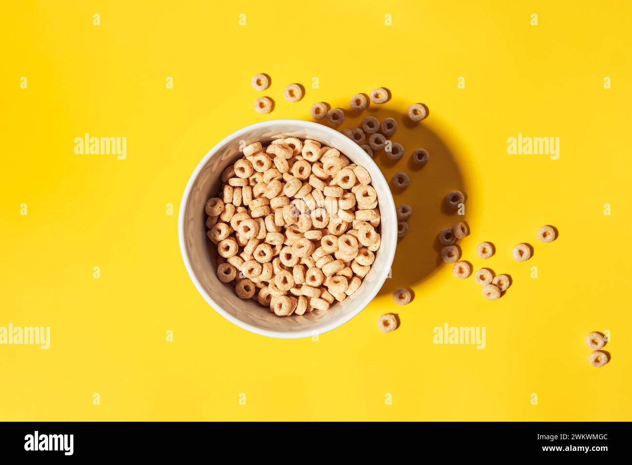 Circle shape cereals in a bow, harsh shadow light, breakfast food ...