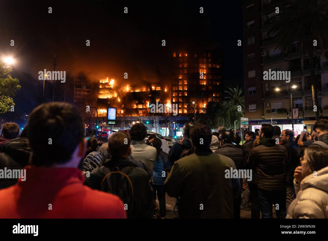 Valencia, Spain - February 22, 2024: A group of people watch a large ...