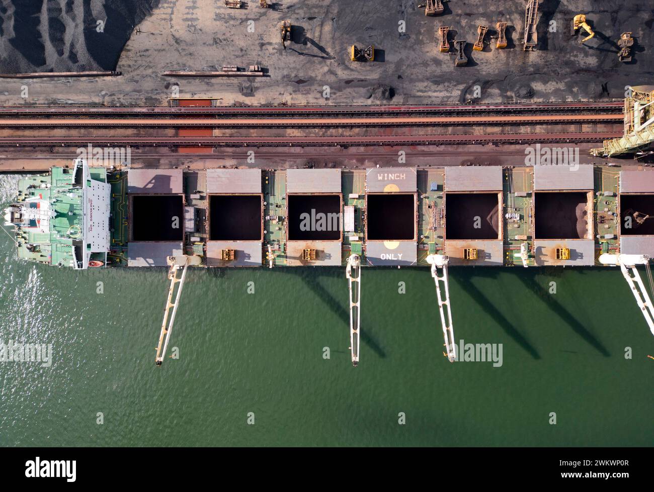 Aerial view of a large bulk carrier supplying iron-ore in a harbor ...