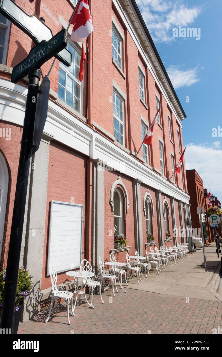 Chairs and tables set up outside a historic building housing a cafe and ...