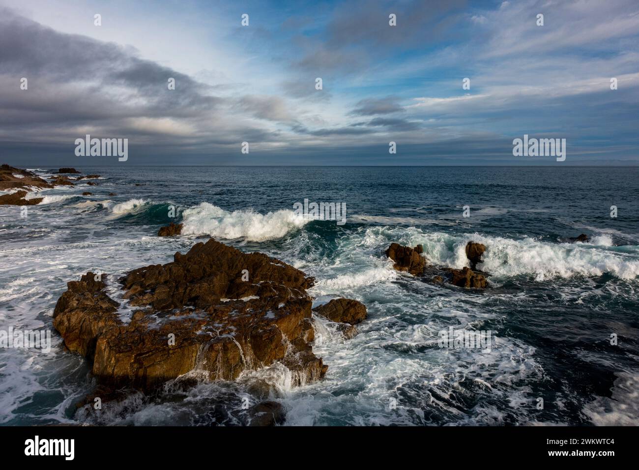 High surf crashes over rocks along shoreline; Pacific Grove, California ...