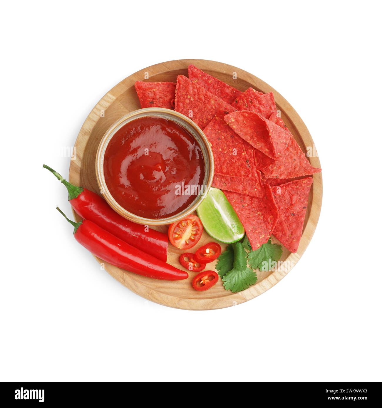 Wooden tray with red nachos, ketchup and chilli on white background ...