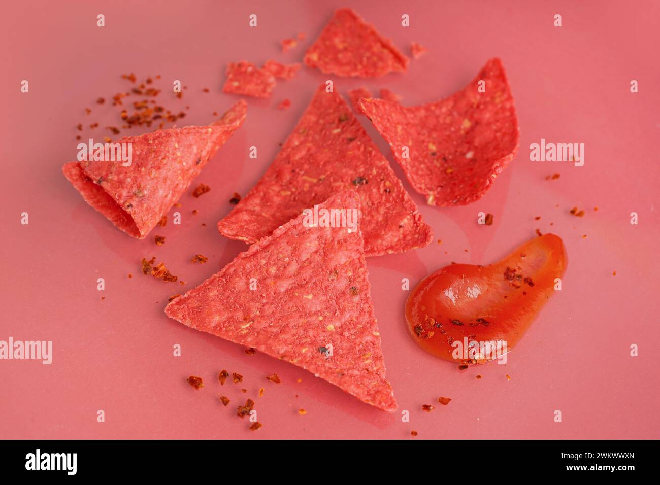 Red nachos with ketchup and ketchup on color background Stock Photo - Alamy