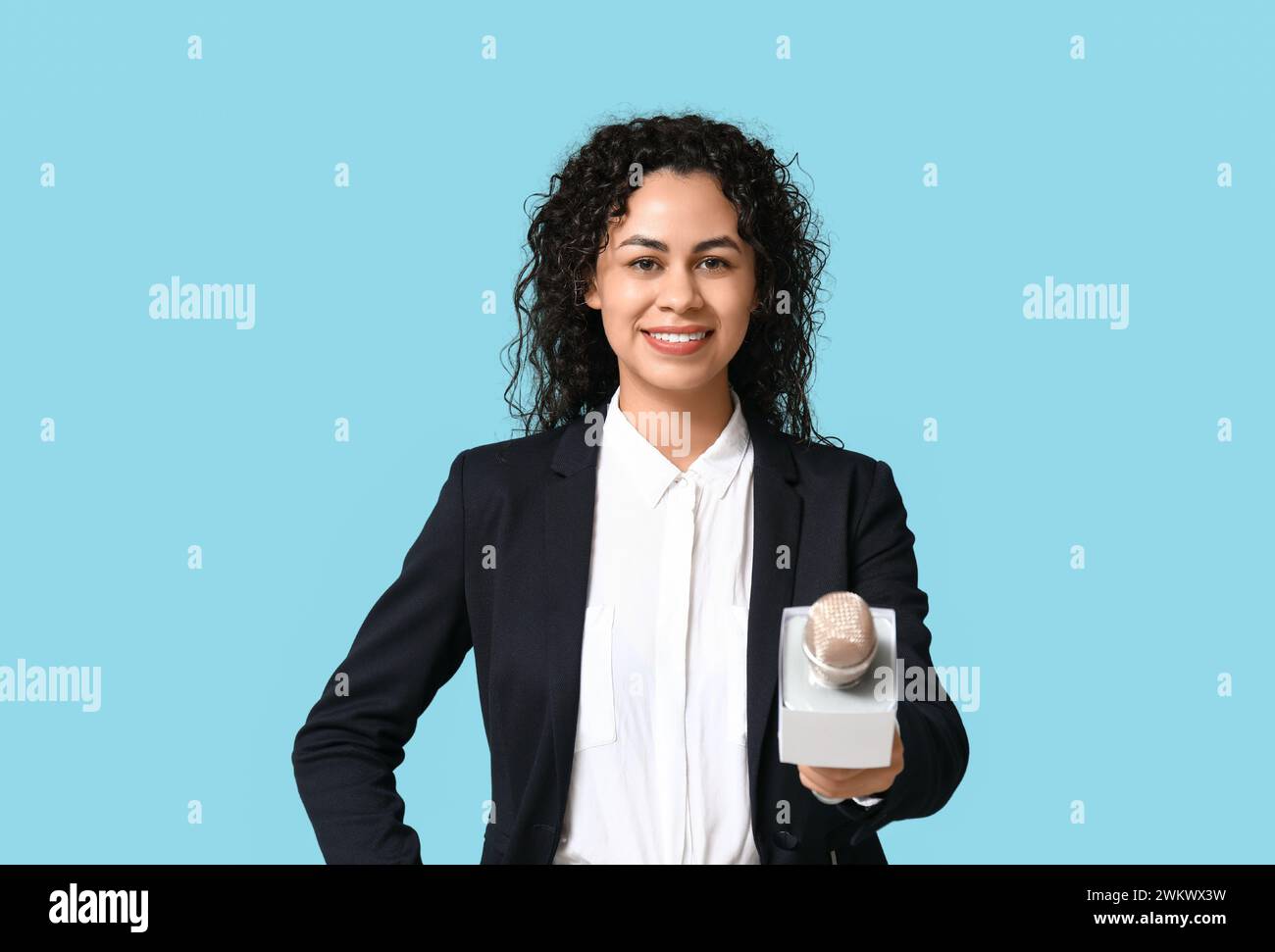 Beautiful young happy African-American female journalist with ...