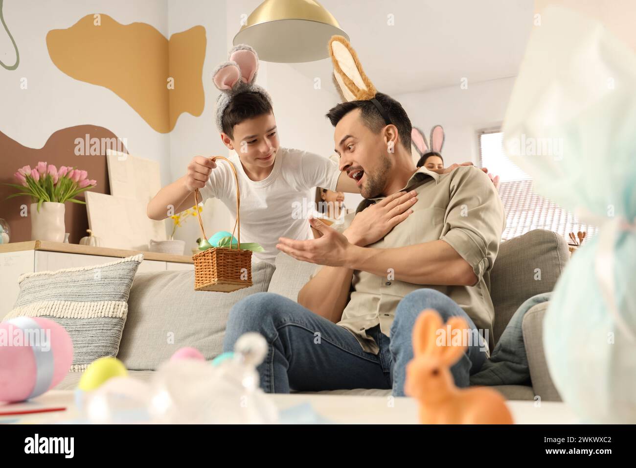 Little boy giving Easter egg to his father at home Stock Photo - Alamy