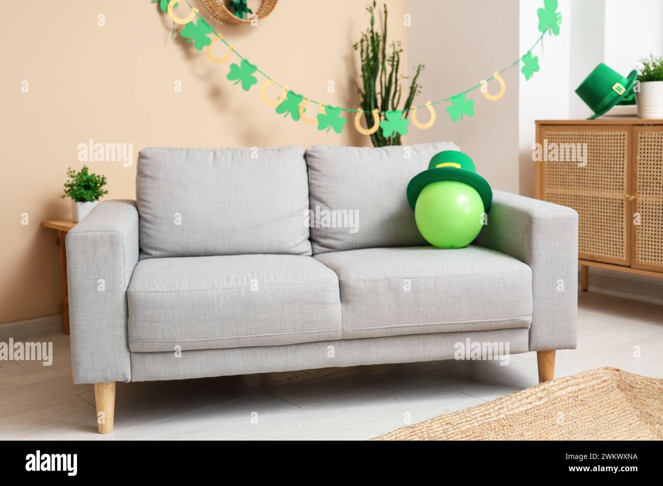 Interior of festive living room with grey sofa and decorations for St ...