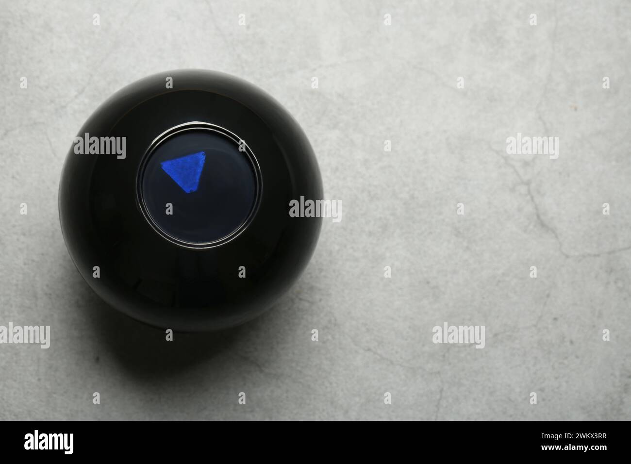 Magic eight ball on grey table, above view. Space for text Stock Photo ...