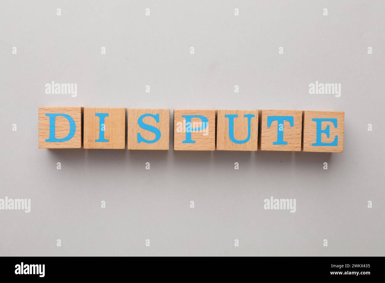 Cubes with word Dispute on light grey background, top view Stock Photo ...