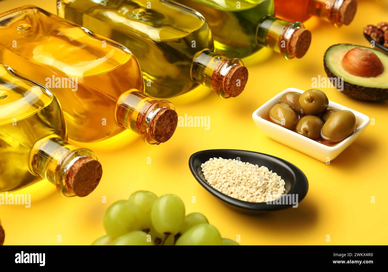 Vegetable fats. Different oils in glass bottles and ingredients on ...