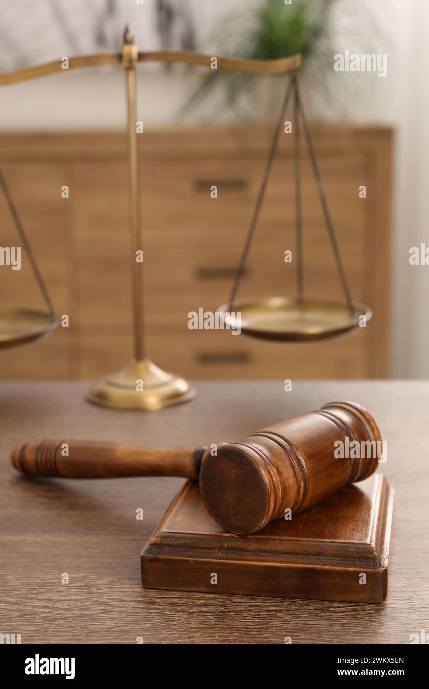 Wooden gavel, sound block and scales on table indoors Stock Photo - Alamy