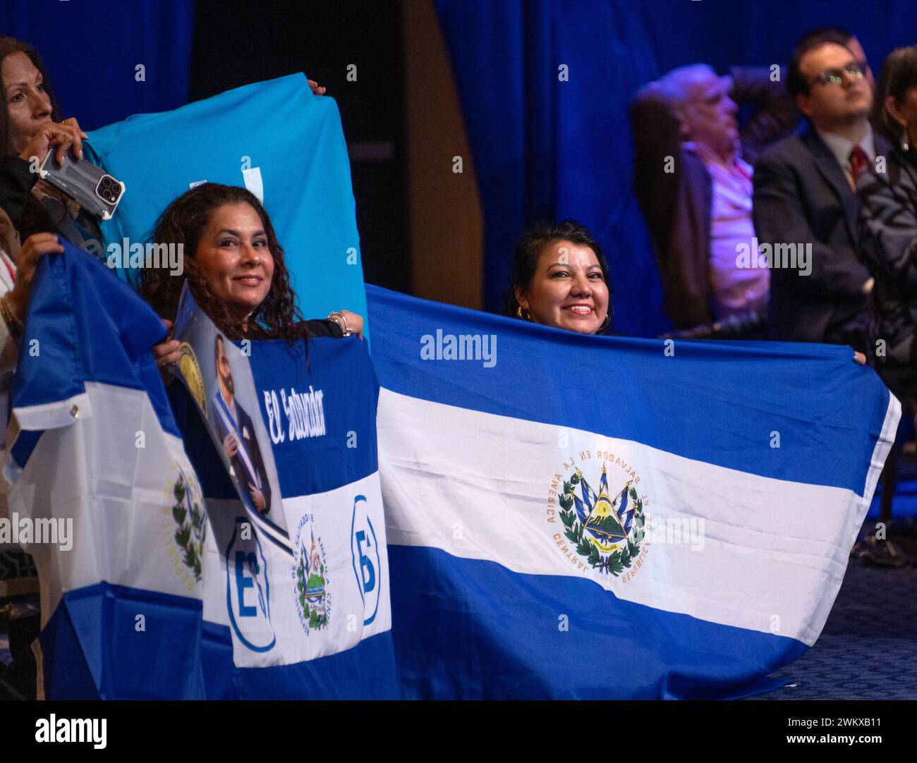 Spectators wave flags as President Nayib Bukele, of El Salvador, makes ...