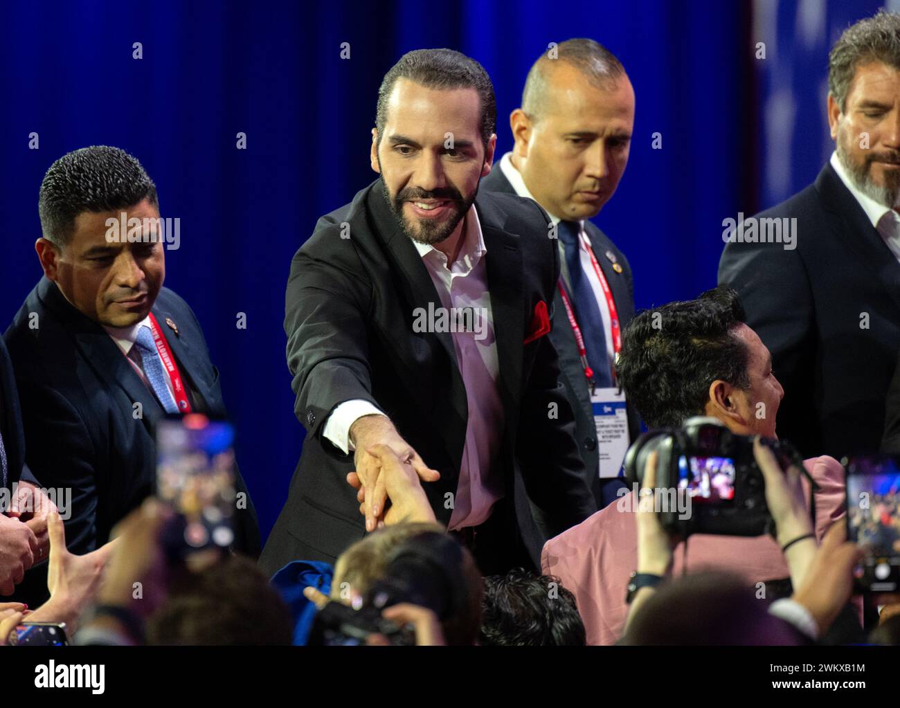 President Nayib Bukele, of El Salvador, shakes hands with a spectator ...