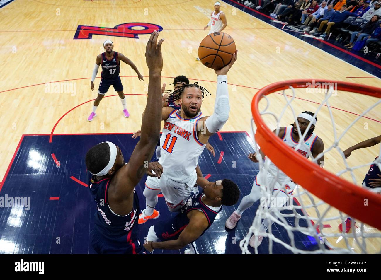 New York Knicks' Jalen Brunson, center, goes up for a shot against ...