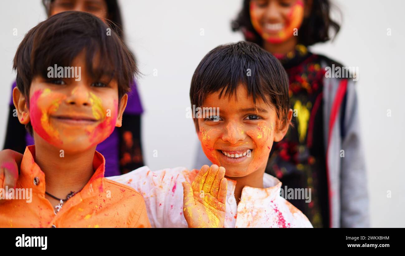 Children covered in colored powder during the festival of Holi. Happy ...