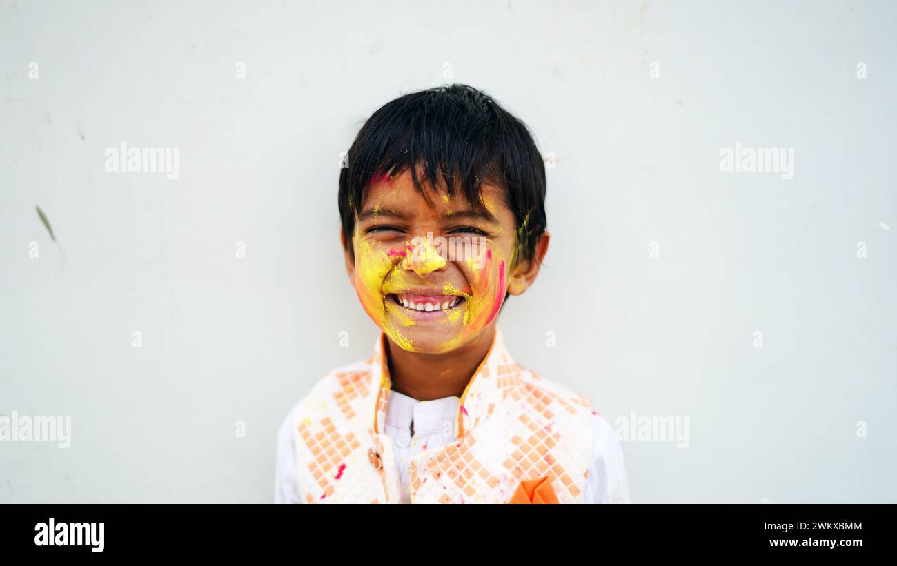 Happy Indian kids playing colours, smiling with colors on face or asian ...