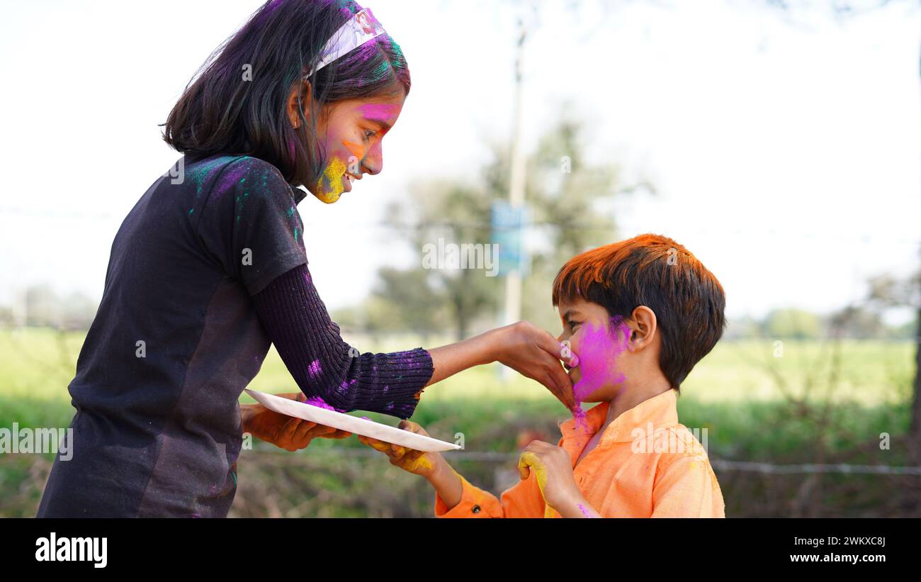 Happy Indian kids playing colours, smiling with colors on face or asian ...