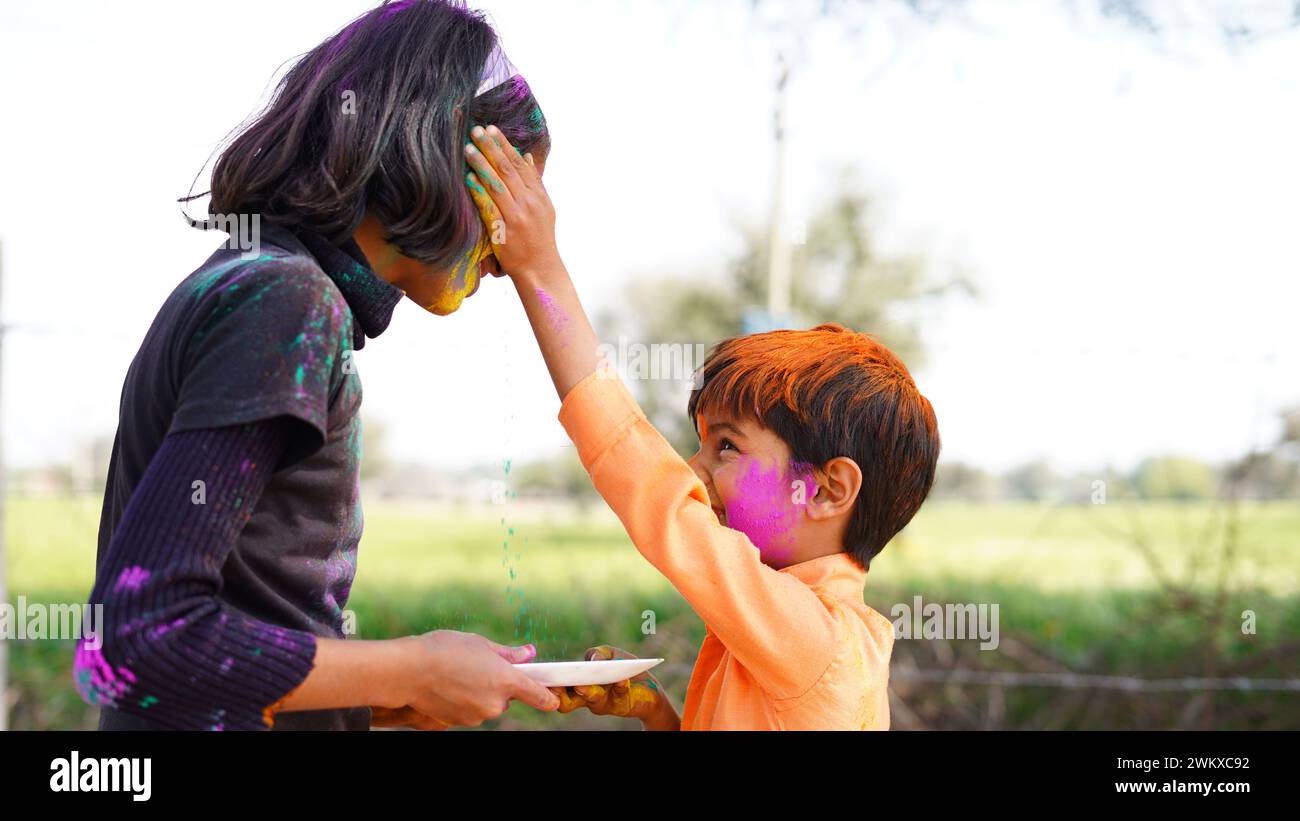 Children covered in colored powder during the festival of Holi. Happy ...
