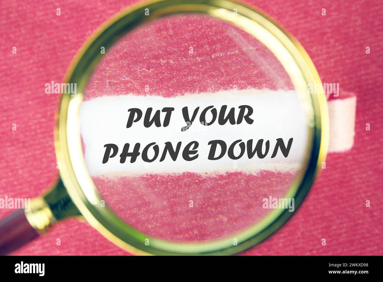 Put Your Phone Down text through a magnifying glass under a torn piece ...