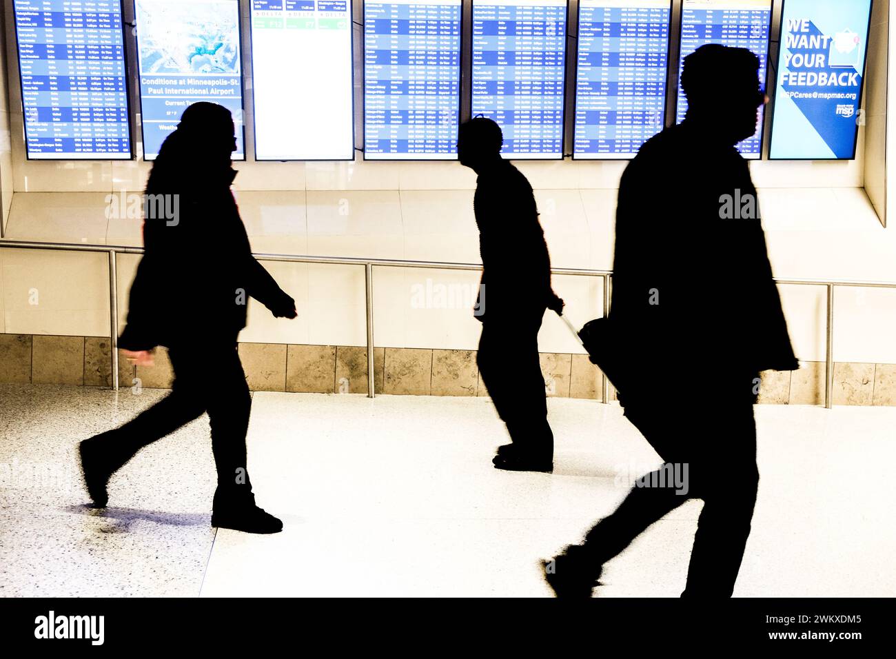 Air travelers and the arrival-departure display at the Minneapolis-St ...