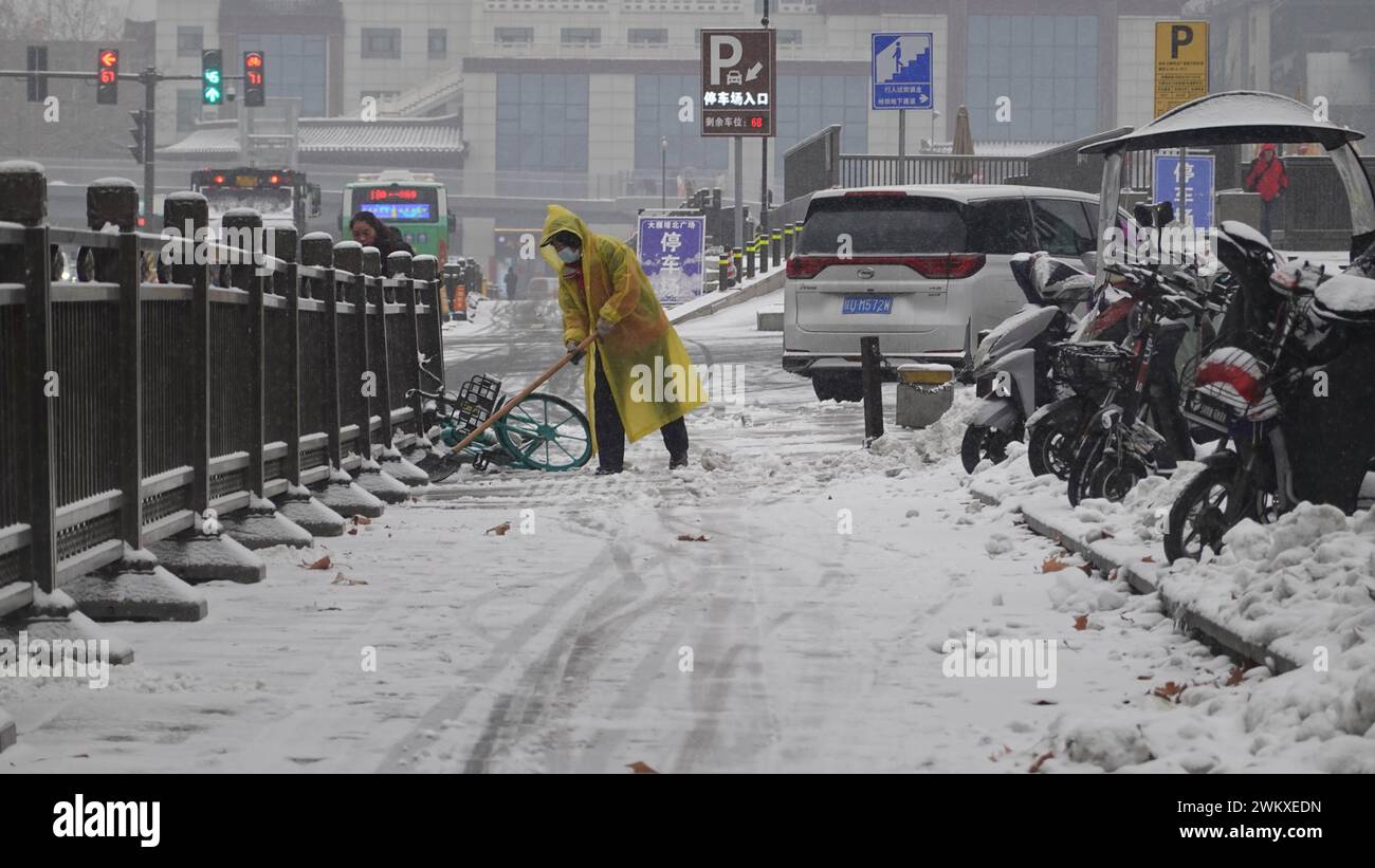 XI'AN, CHINA - FEBRUARY 23, 2024 - Workers clear snow at the Grand Tang ...