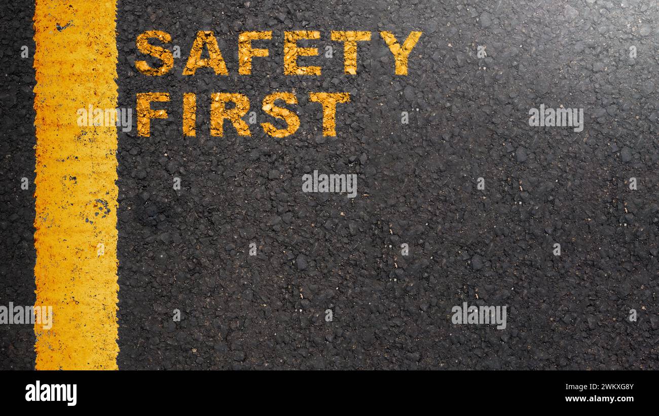 'Safety first' text on the asphalt road. Safety first concept Stock ...