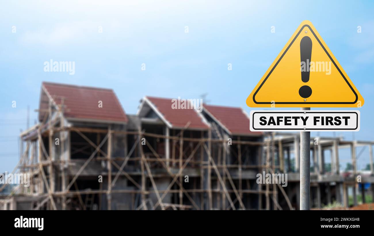 A traffic sign with 'safety first' text with a construction site ...