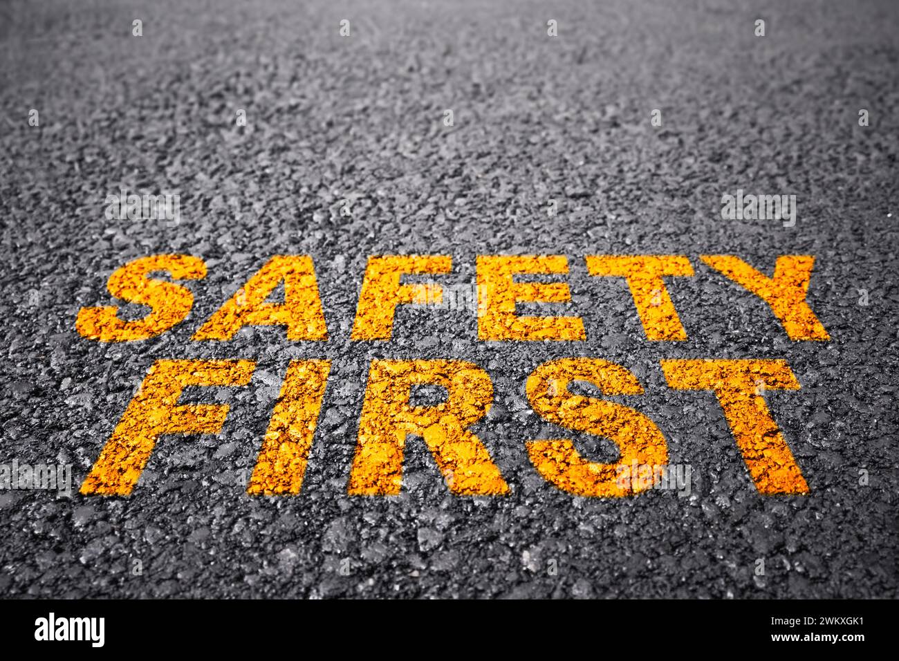 Safety first with yellow sign on asphalt road, warning concept of ...