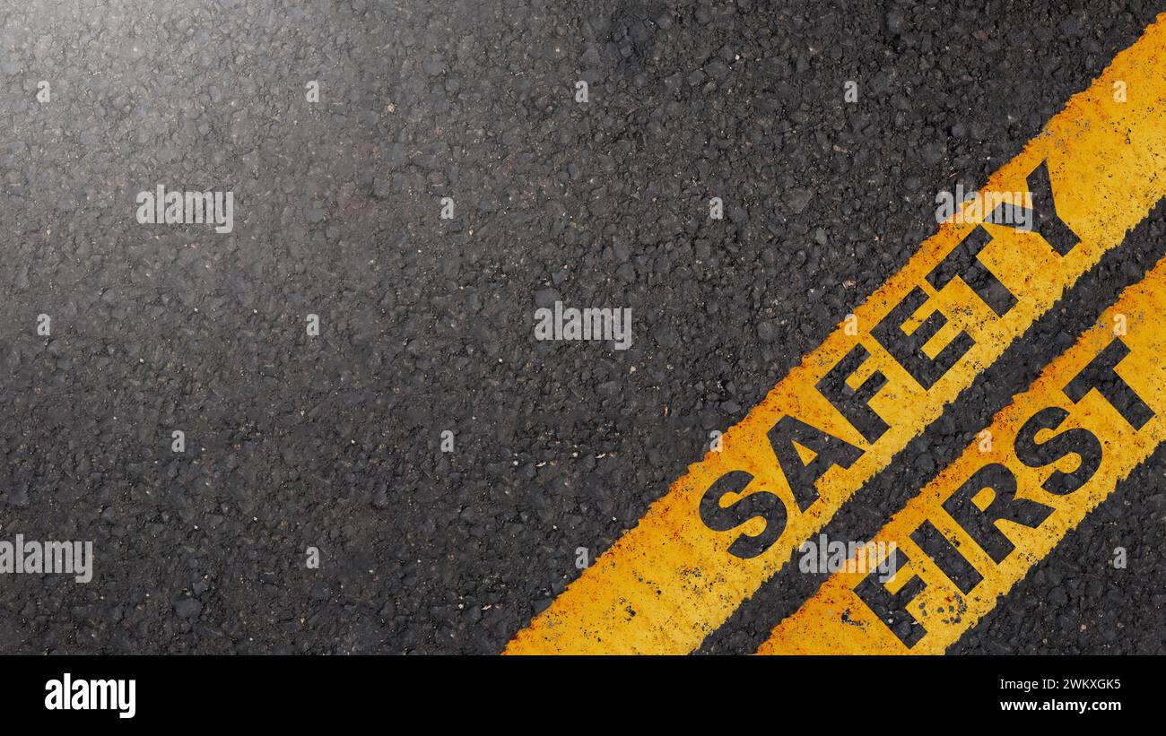 Safety first with yellow sign on asphalt road, warning concept of ...