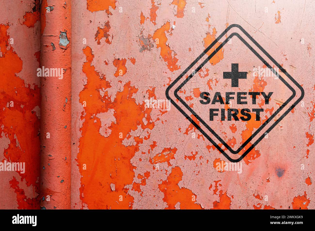 Text of safety first sign on grunge red wall background as a warning ...