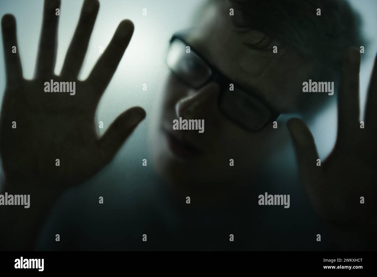Scary, mystery and man with hands on glass, window and trapped in home ...