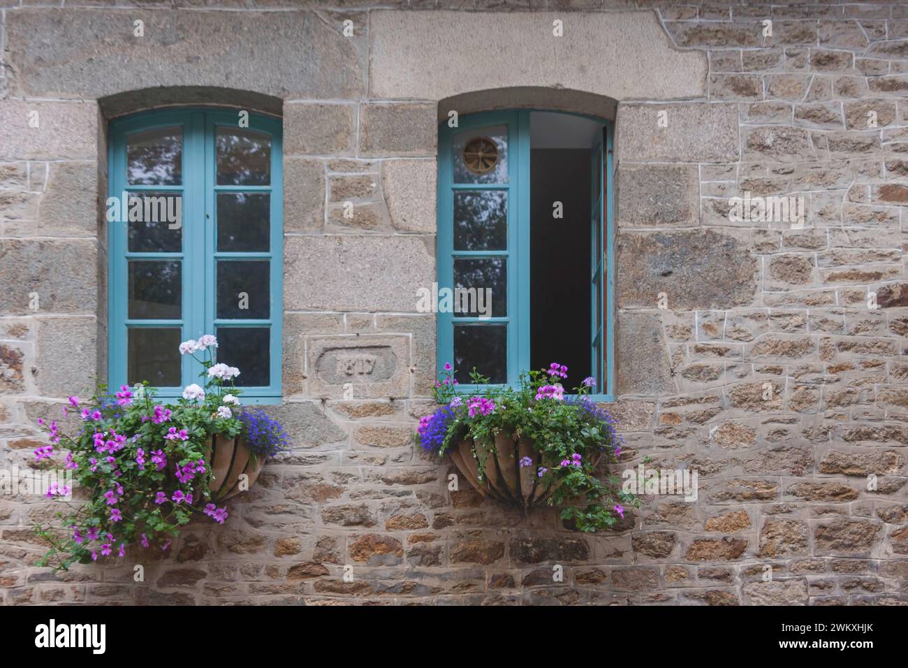 Two windows in a typical granite house, floral decoration, Dinan old ...