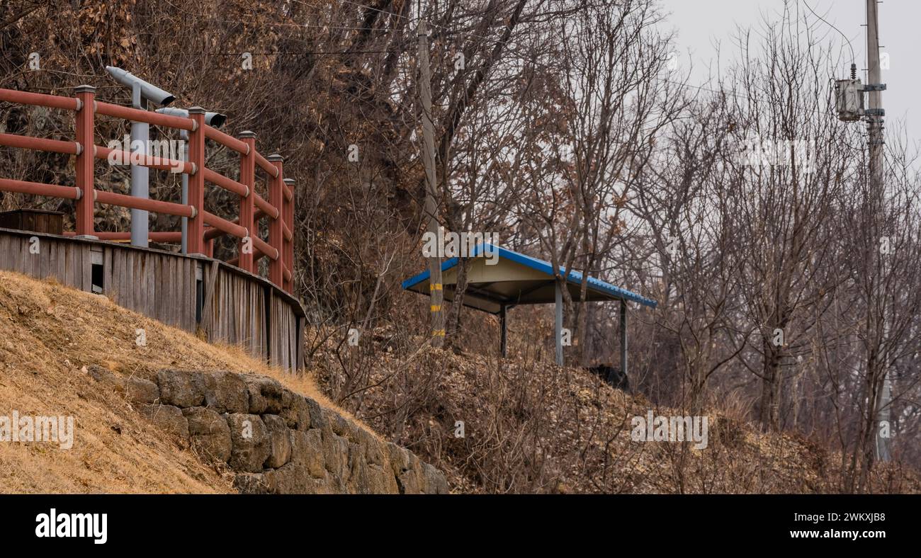 Wooden observation platform with two viewing binoculars behind red ...