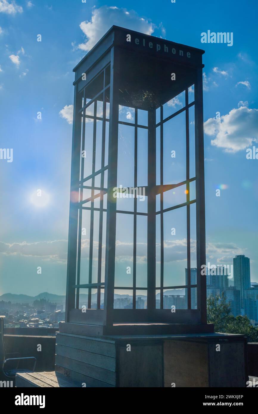 Red wooden telephone booth minus phone and without glass on roof of ...