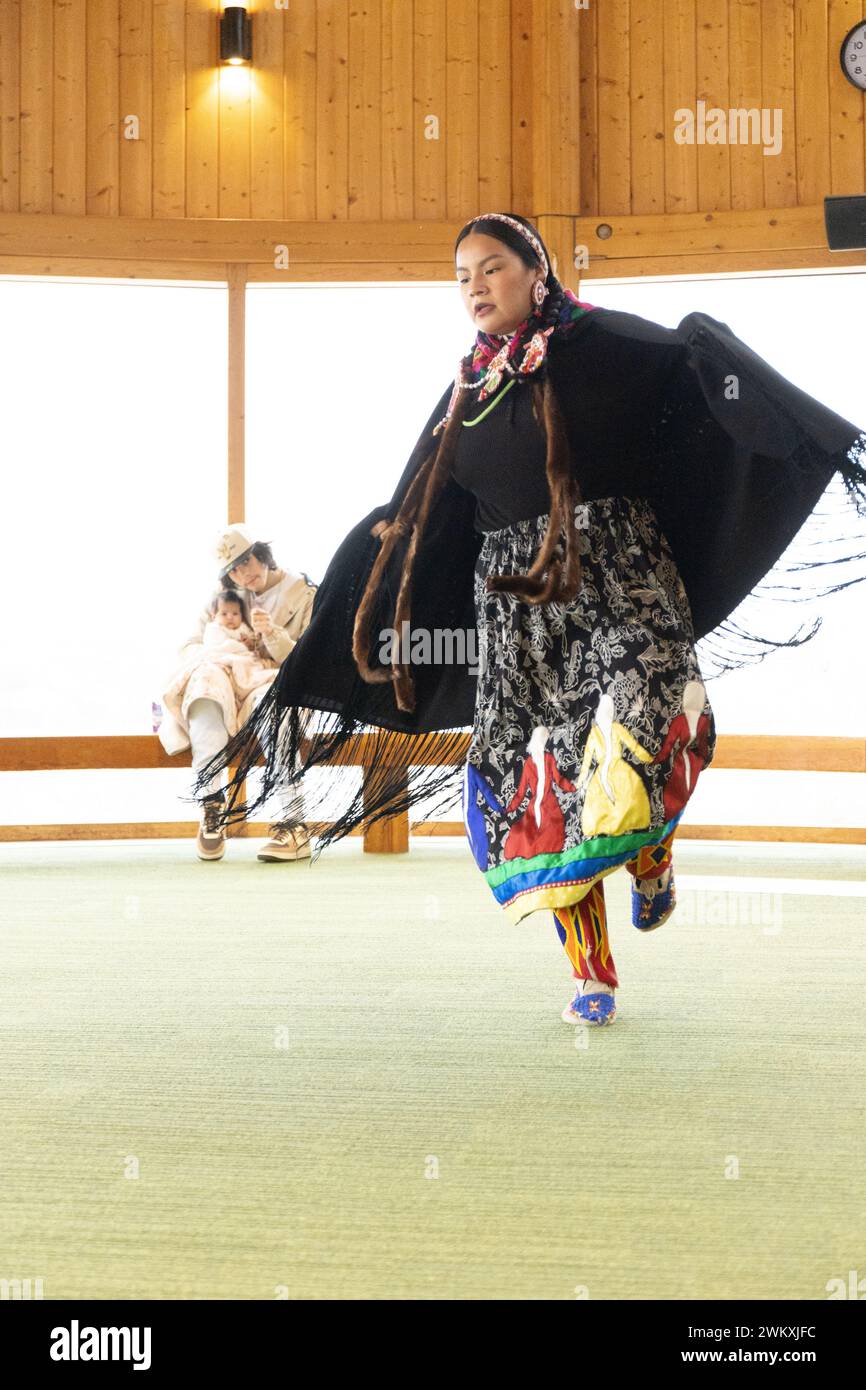 A young ethnic native woman, in traditional costume, performs a sacred ...