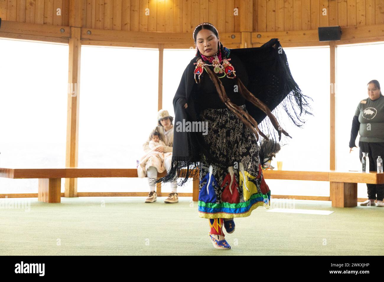 A young ethnic native woman, in traditional costume, performs a sacred ...