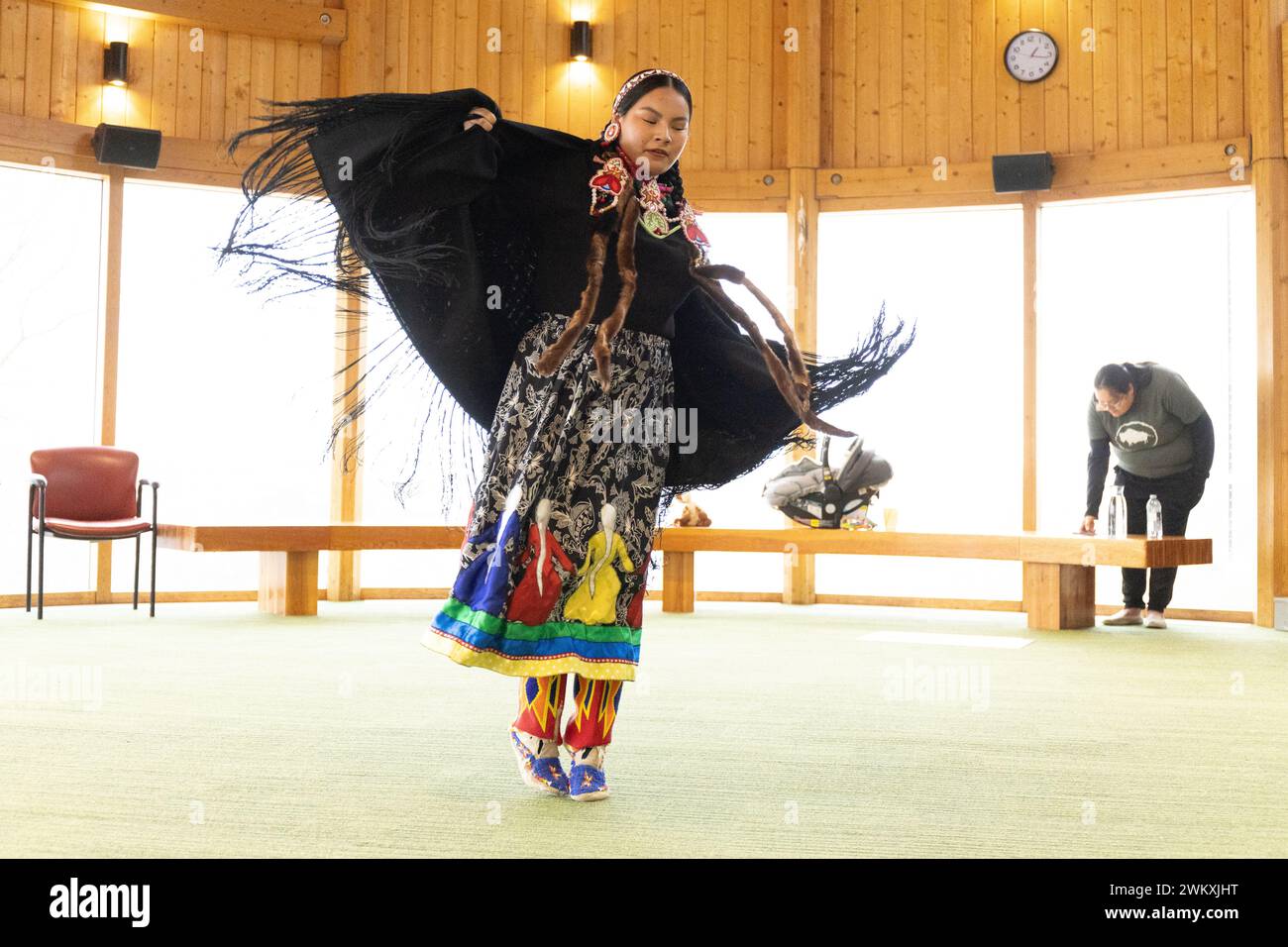 A young ethnic native woman, in traditional costume, performs a sacred ...