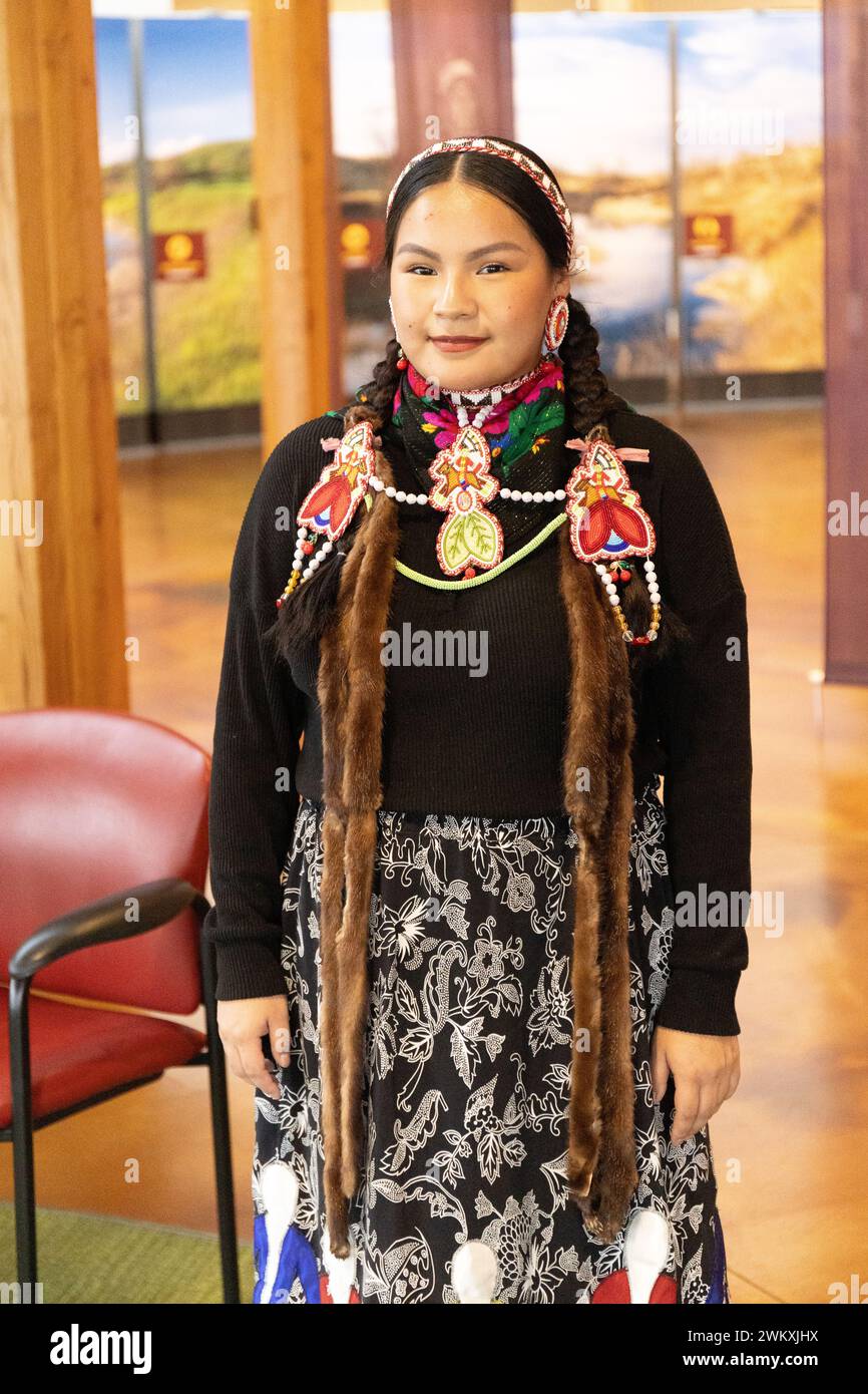 A young ethnic native woman, in traditional costume, performs a sacred ...