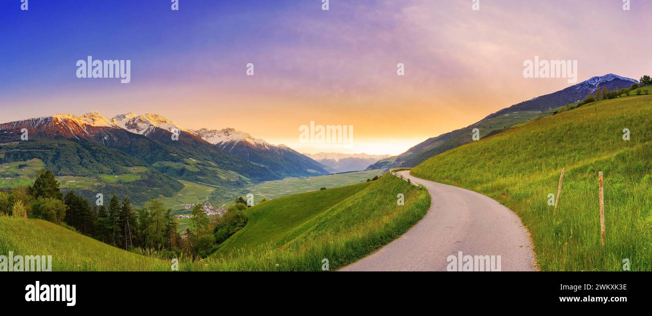 Mountain panorama of a small road in the South Tyrolean Alps, sunset ...